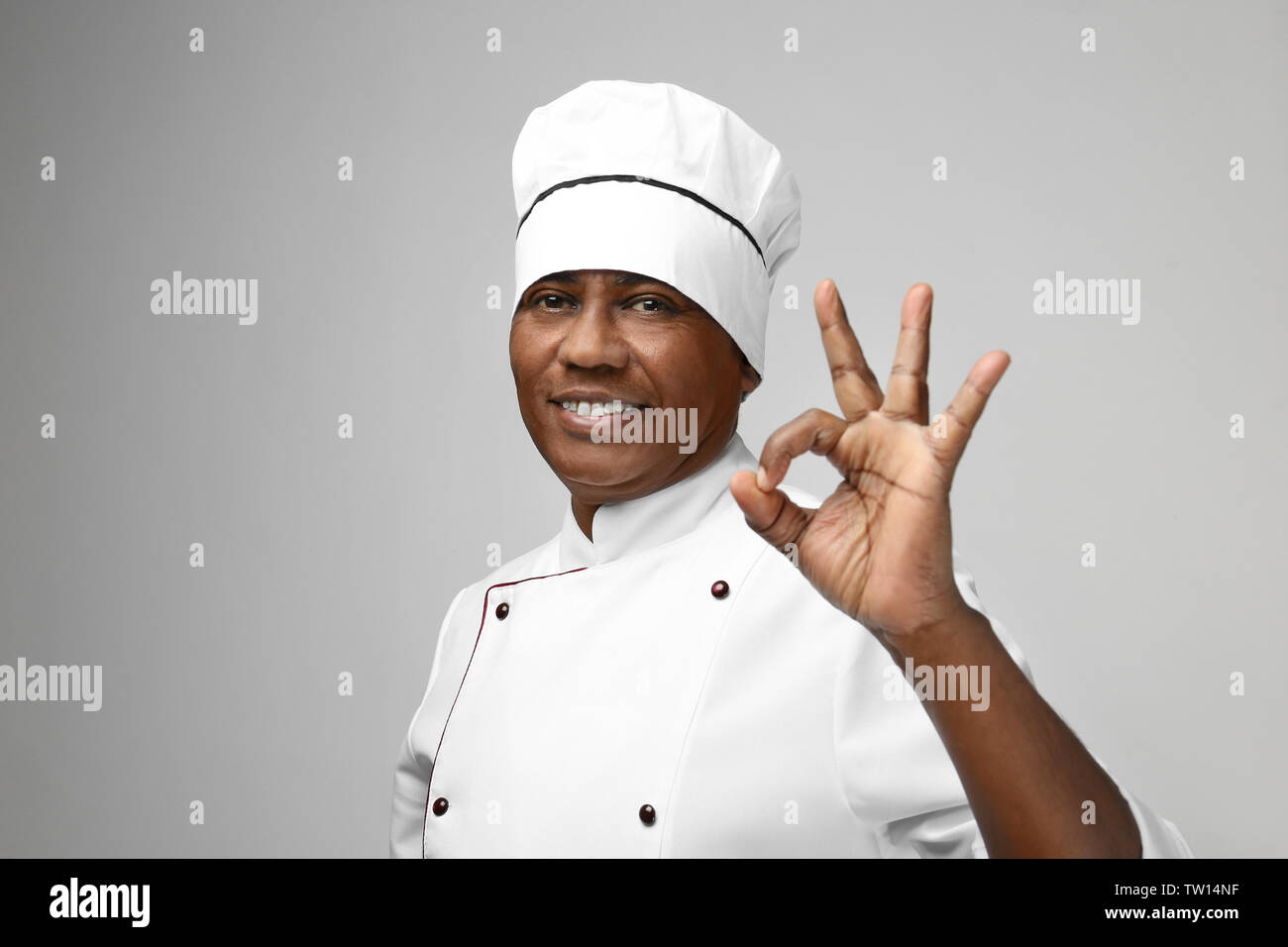Indian chef in uniform on light background Stock Photo - Alamy