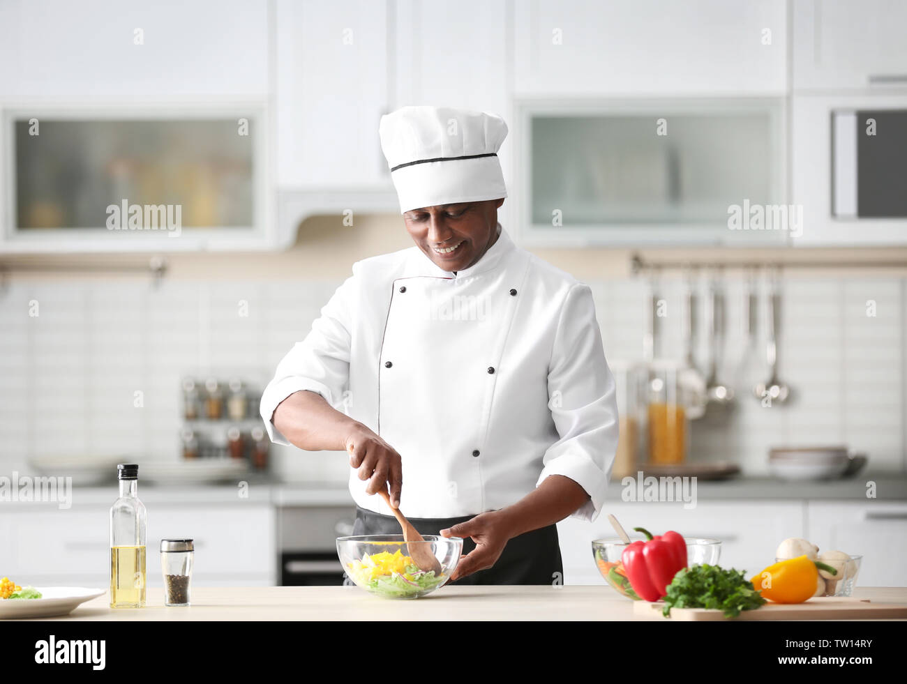 Mature Indian chef cooking in kitchen Stock Photo - Alamy