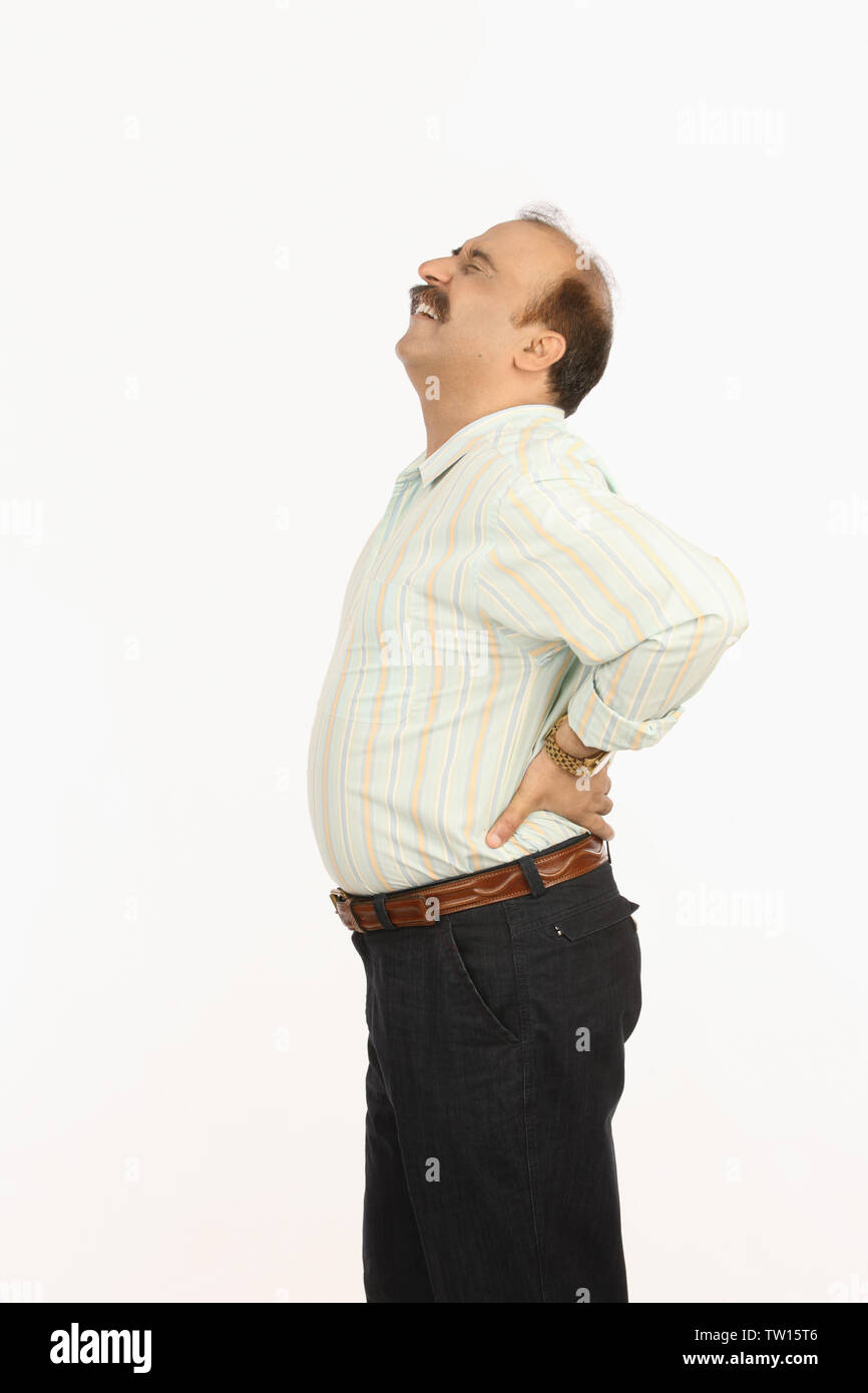 Side profile of a man suffering from lower back pain Stock Photo - Alamy