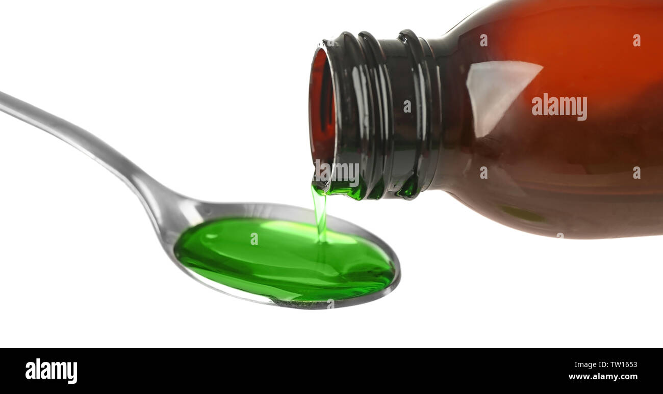 Pouring cough medicine syrup into spoon on white background Stock Photo ...