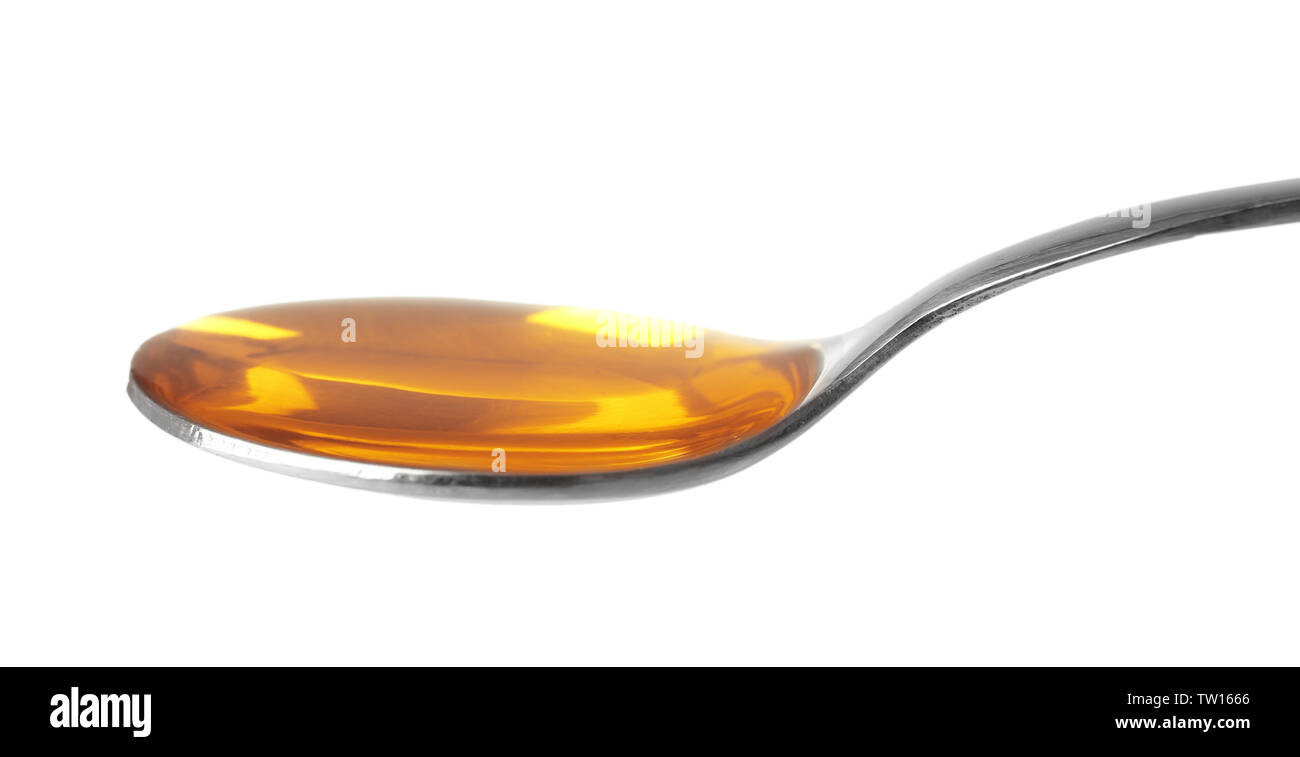 Yellow cough medicine syrup in silver spoon isolated on white Stock ...