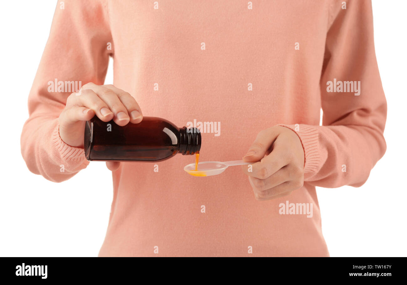 Woman pouring cough medicine syrup into spoon on white background Stock ...