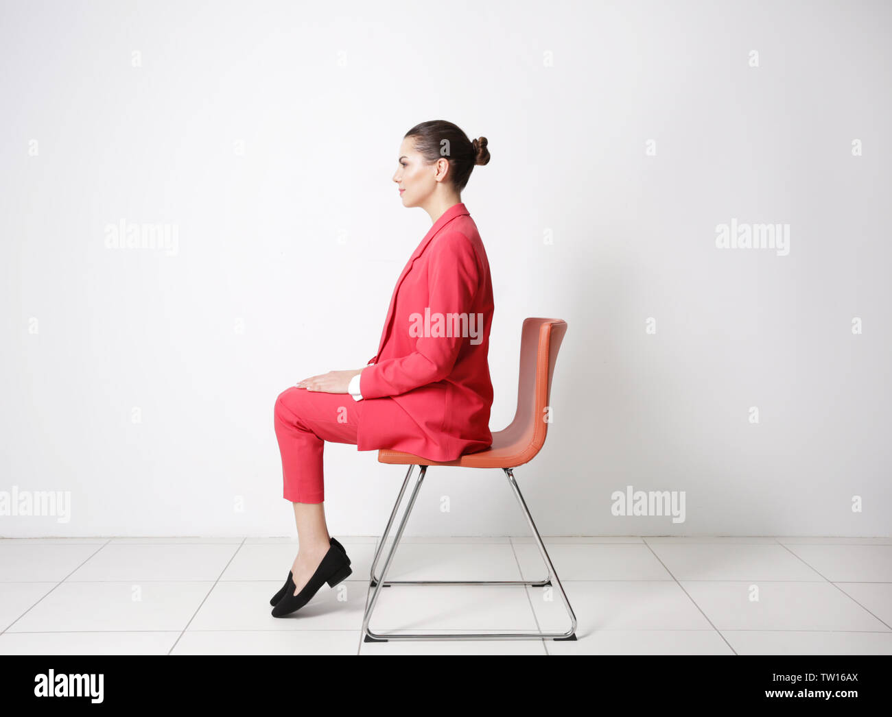 Incorrect posture concept. Young woman sitting on chair against white ...