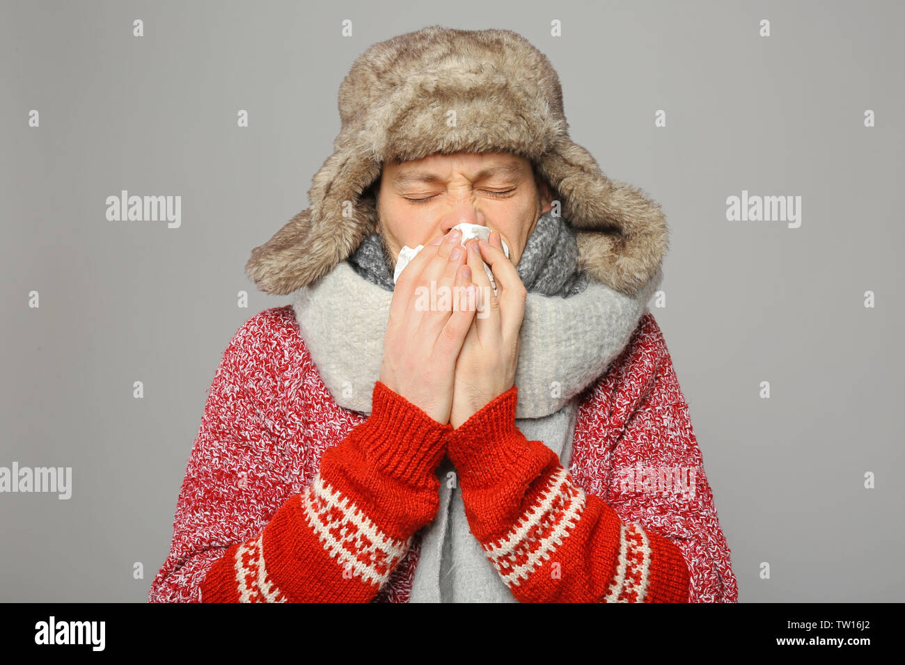 Young ill man on grey background Stock Photo - Alamy