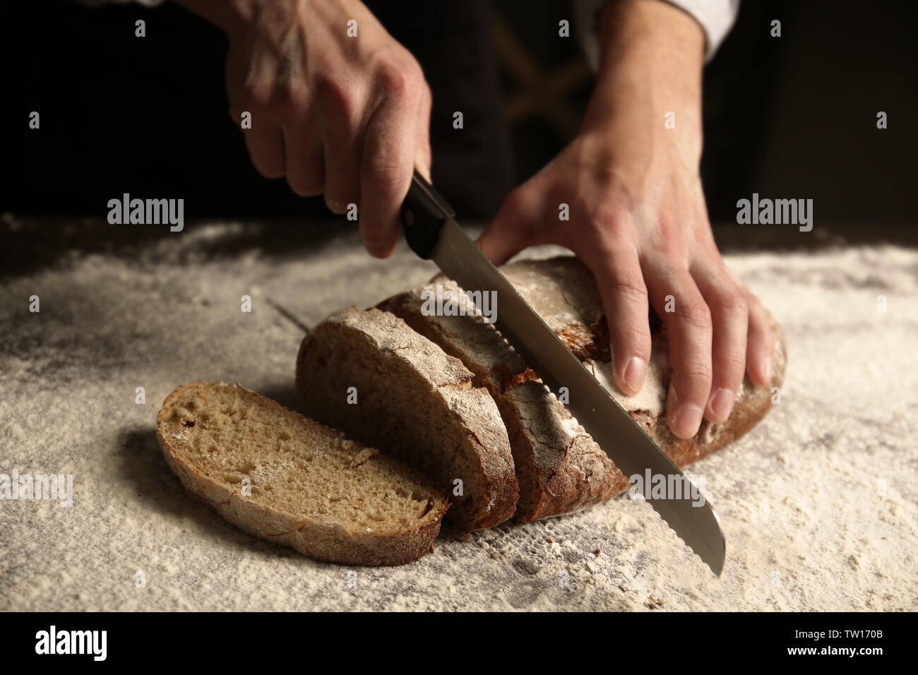 Male hands cutting rye bread hi-res stock photography and images - Alamy