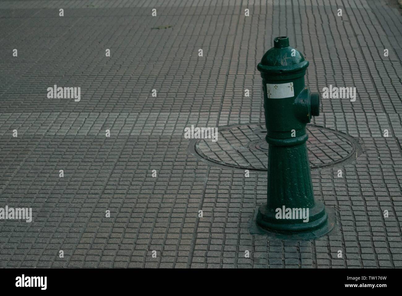 Green fire hydrant on textured cement Stock Photo - Alamy
