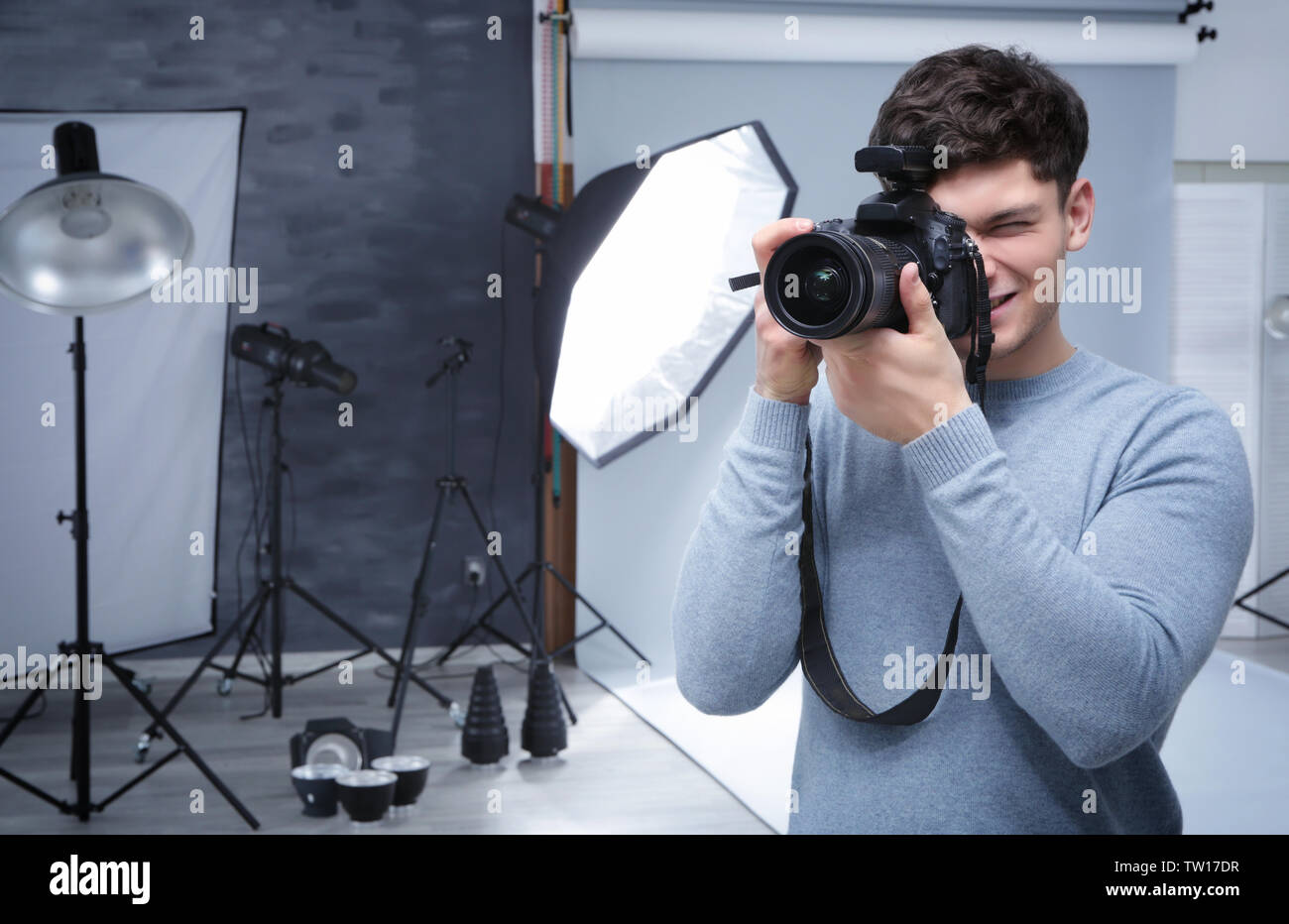 Young photographer in process working hi-res stock photography and ...