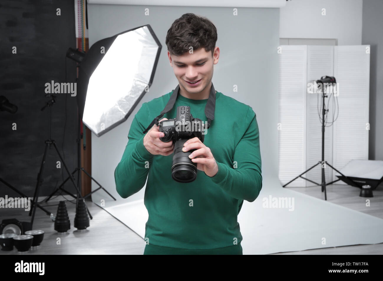 Young photographer in process working hi-res stock photography and ...