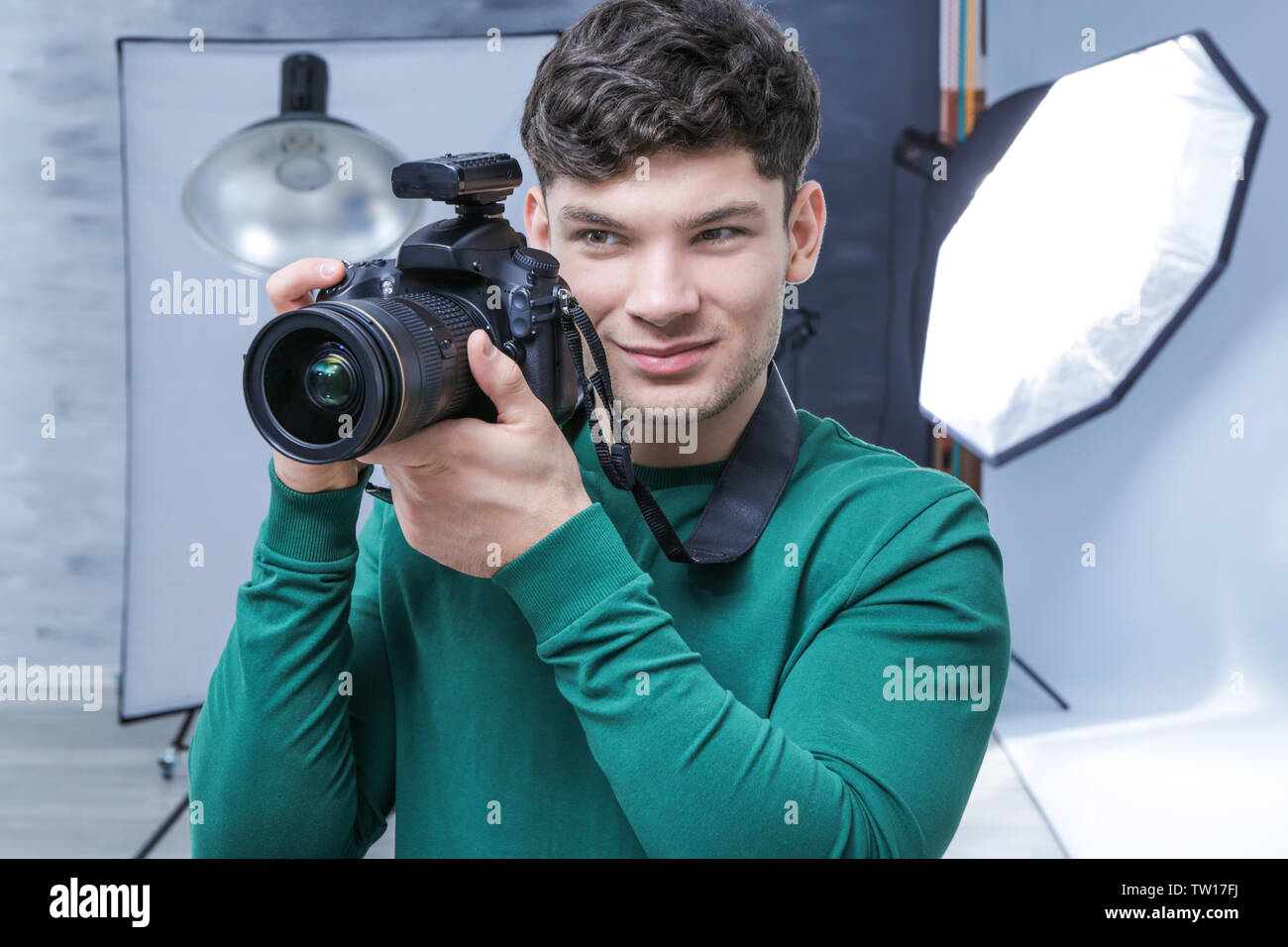 Young photographer in process working hi-res stock photography and ...