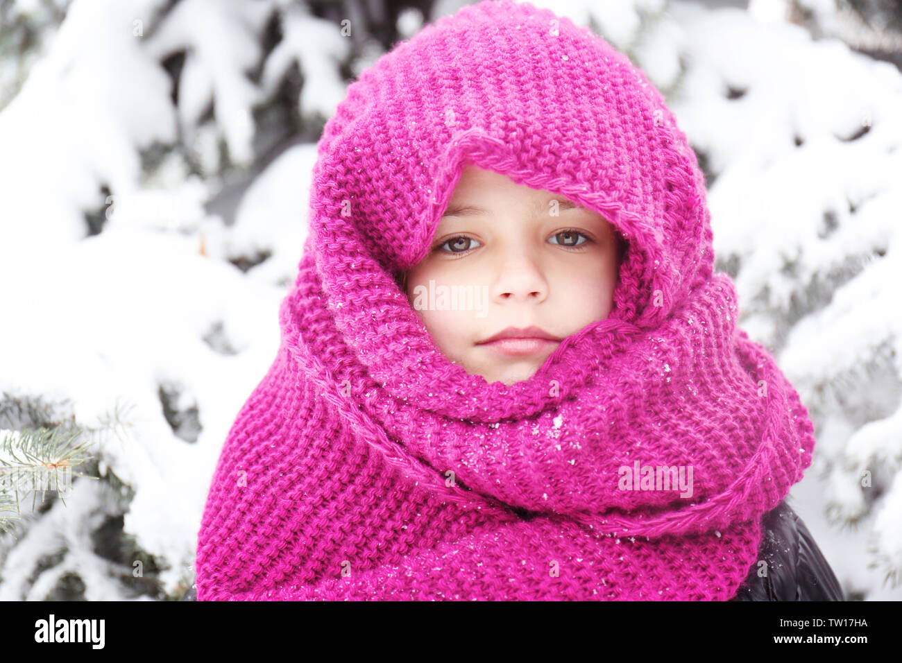 Closeup portrait of cute little girl wearing warm knitted snood ...