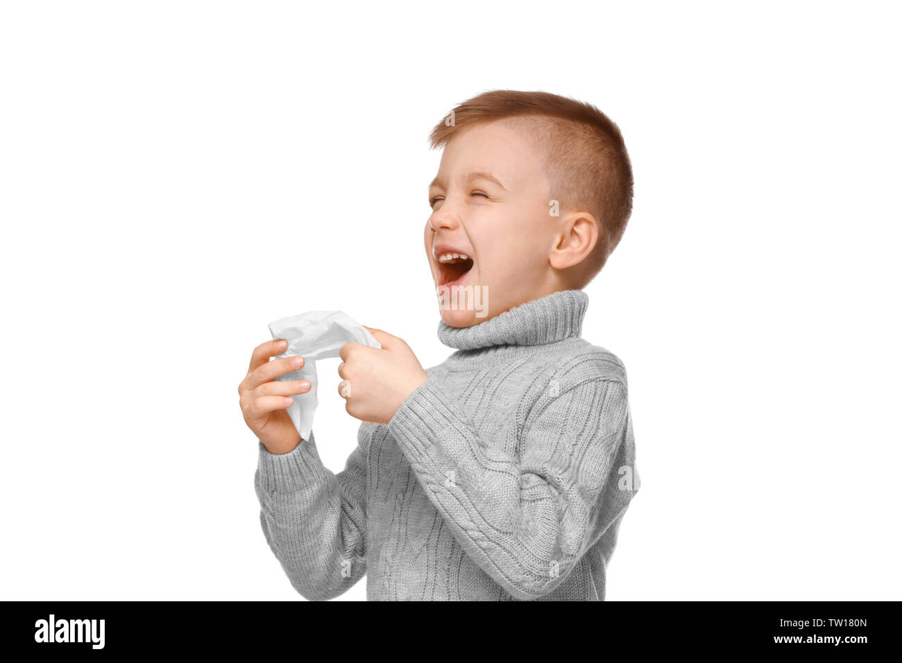 Cute little boy sneezing in tissue on white background Stock Photo - Alamy