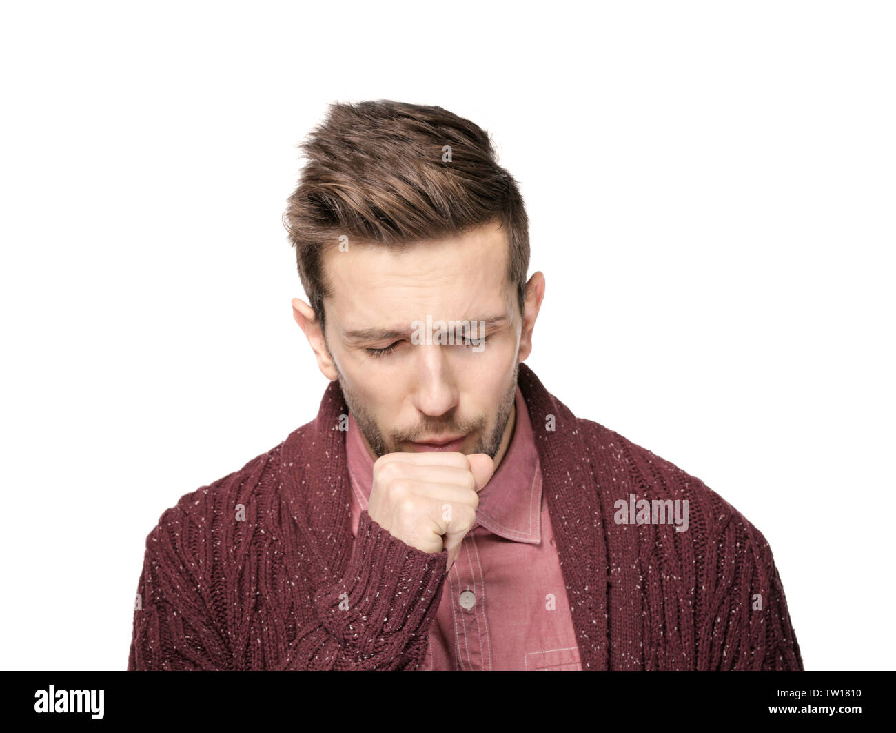 Young man coughing on light background Stock Photo - Alamy