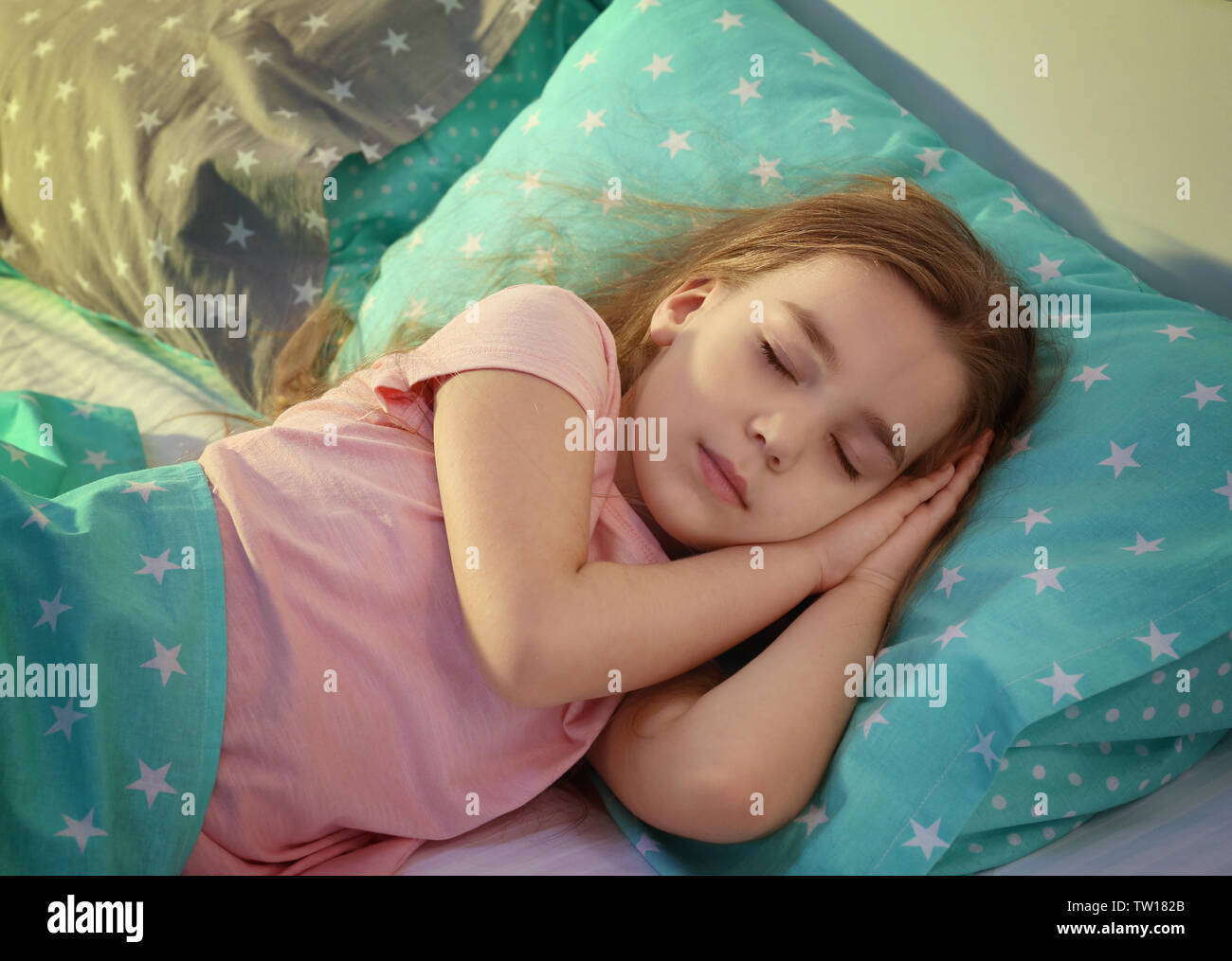 Cute little girl sleeping in bed Stock Photo - Alamy