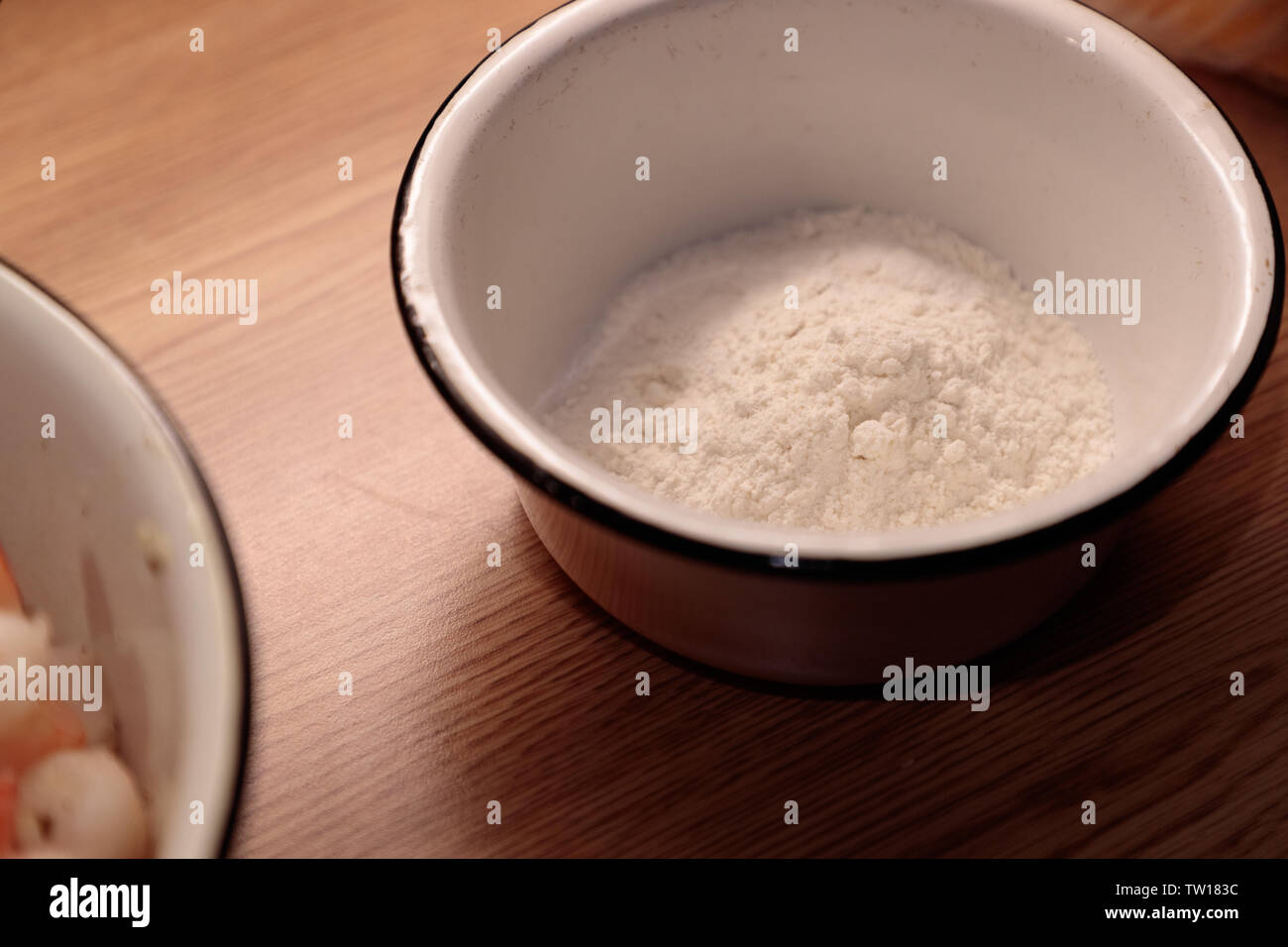 flour in a bowl on the kitchen table Stock Photo - Alamy