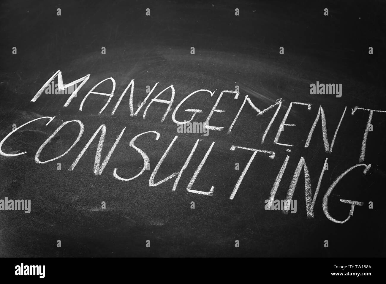 Phrase MANAGEMENT CONSULTING written on blackboard Stock Photo - Alamy