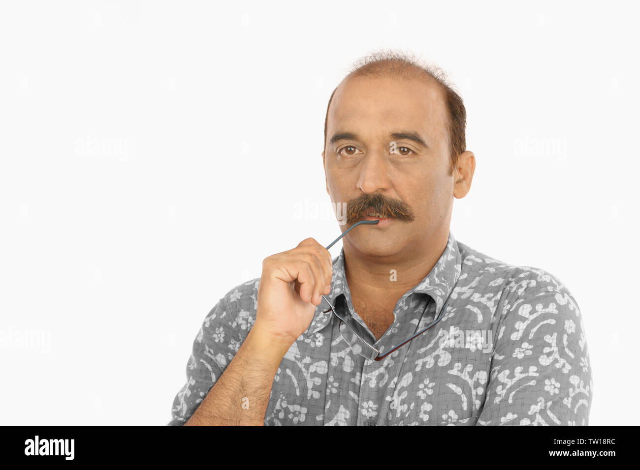 Portrait of an Indian man thinking Stock Photo - Alamy