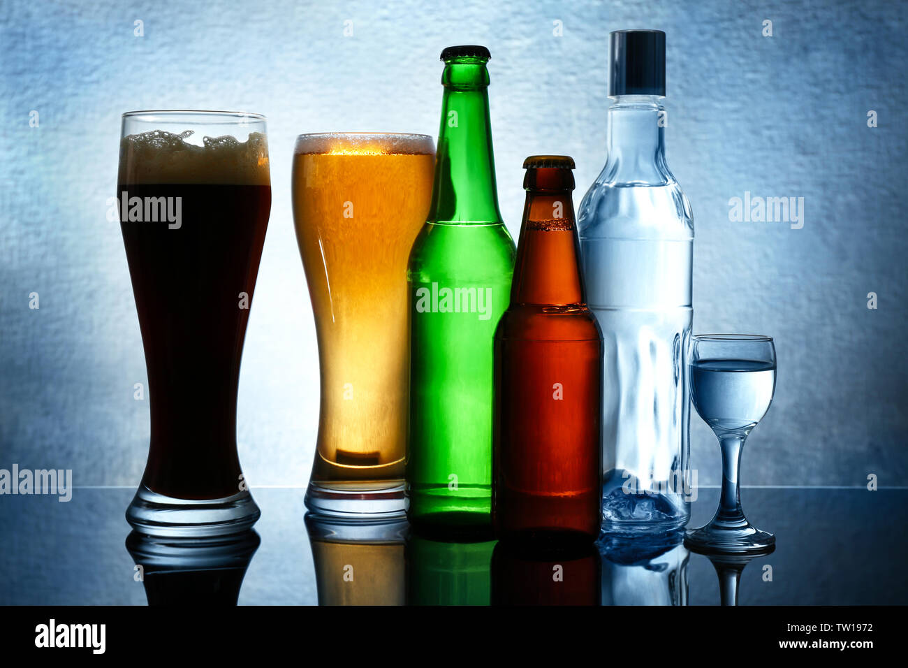 Different bottles of wine and spirits on color background Stock Photo ...