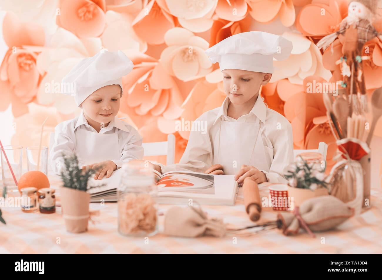 two cute little cooks start cooking dinner. photo with copy space Stock ...