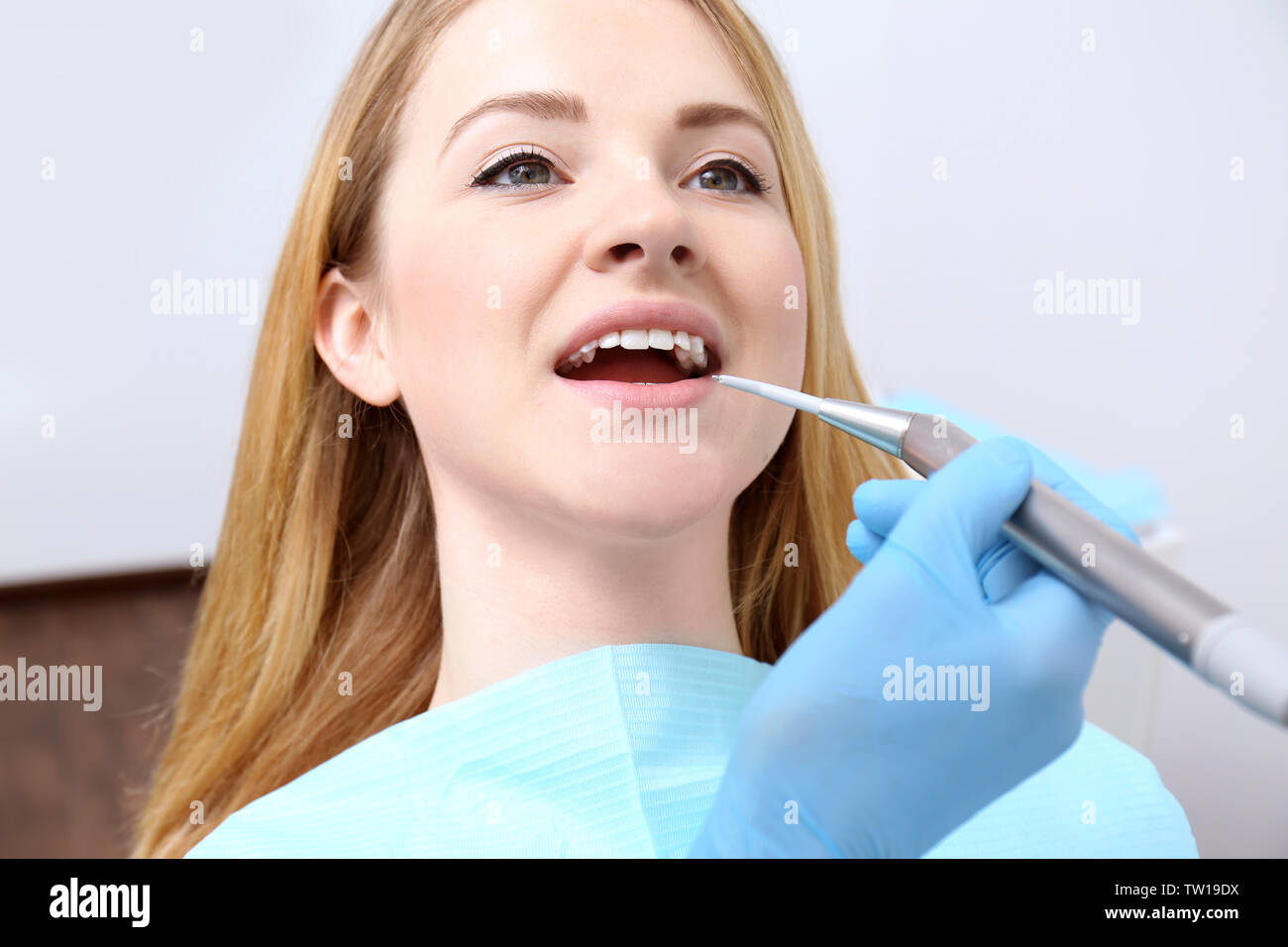 Dentist examining patient's teeth in clinic Stock Photo - Alamy