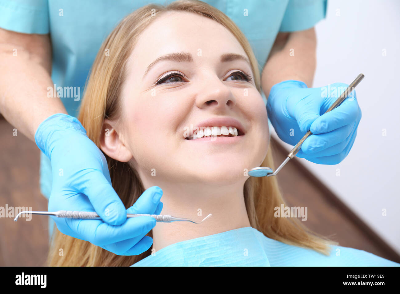 Dentist examining patient's teeth in clinic Stock Photo - Alamy