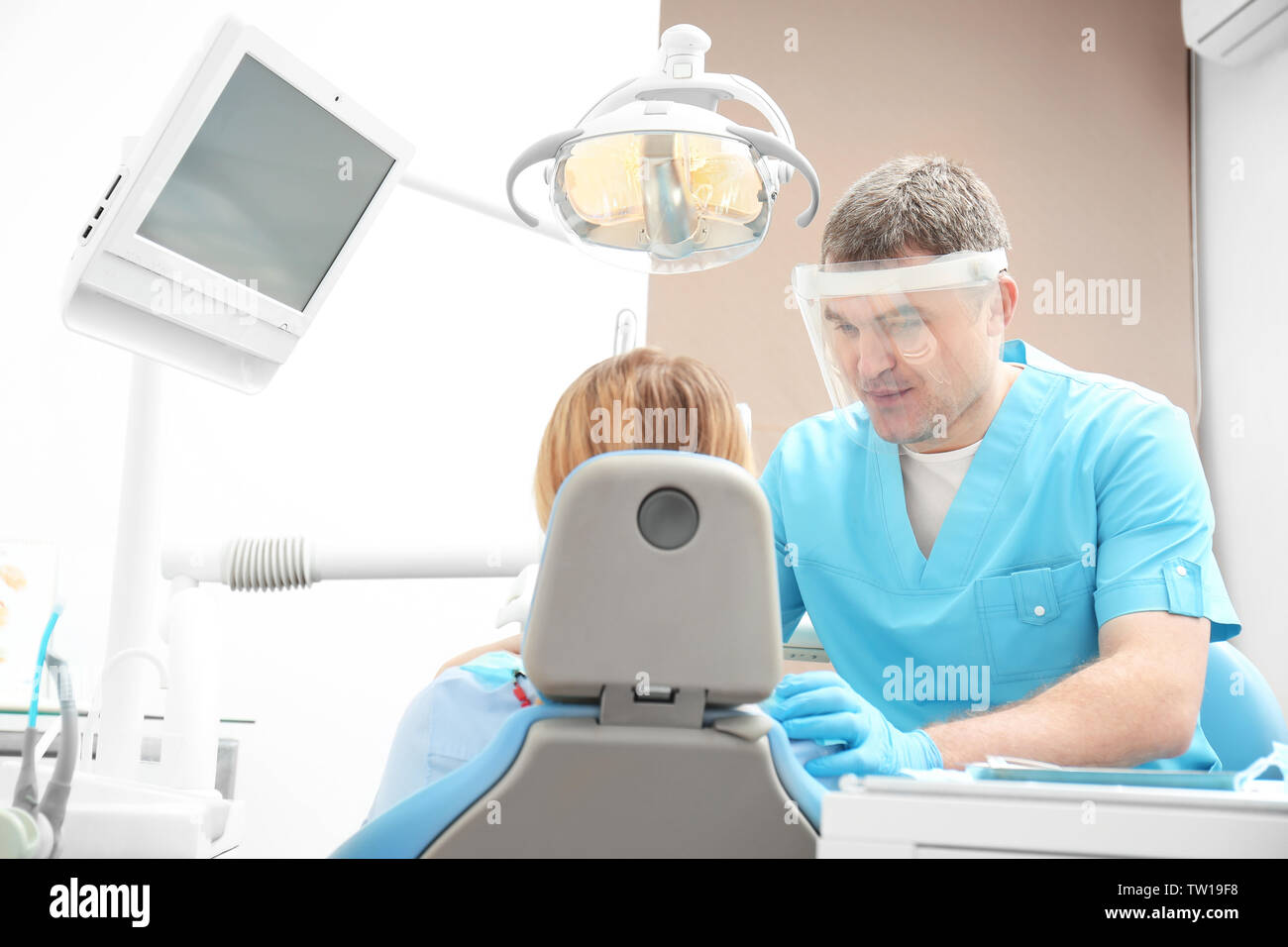 Dentist examining patient's teeth in clinic Stock Photo - Alamy