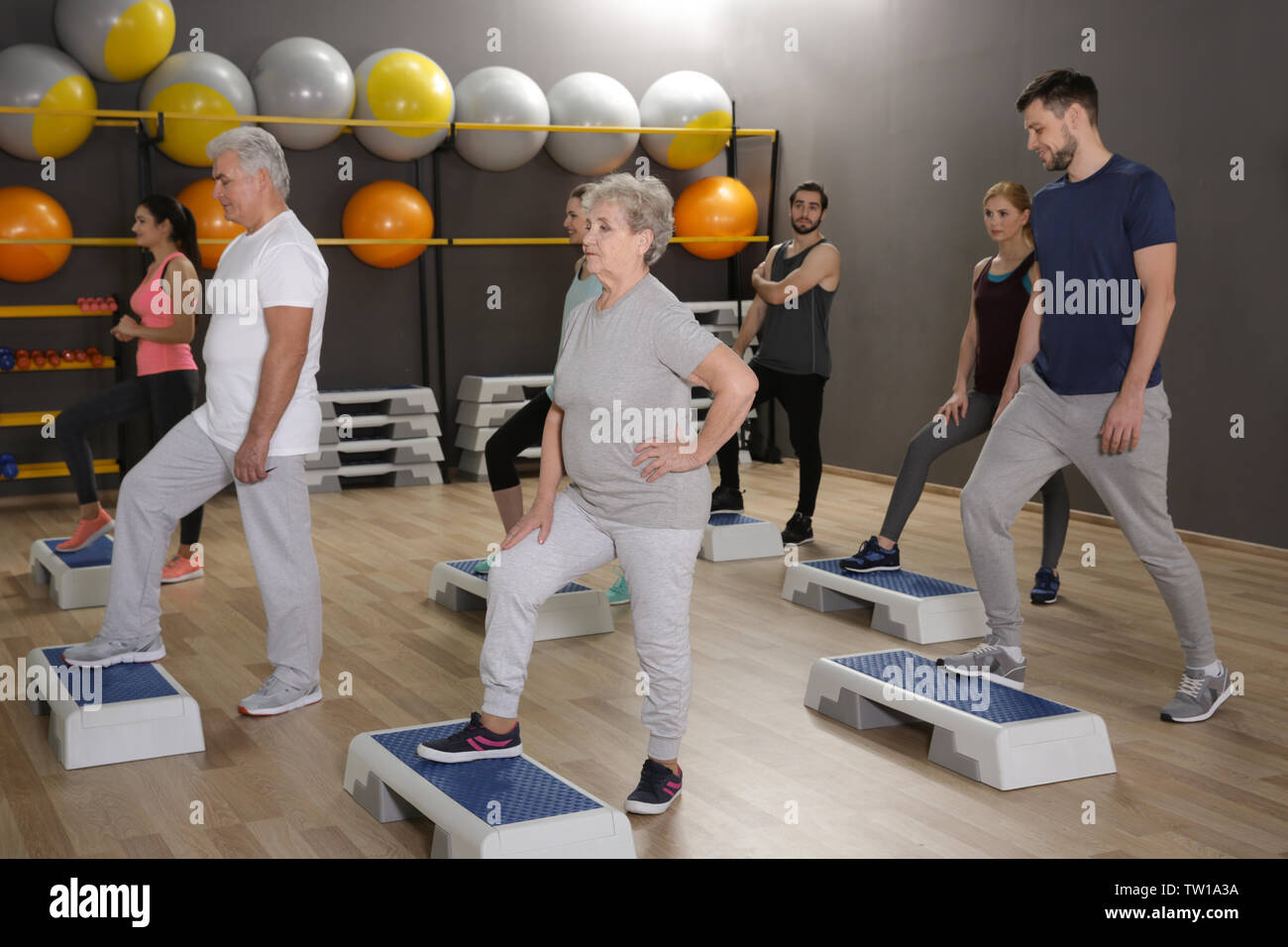 People of different ages training in gym Stock Photo - Alamy