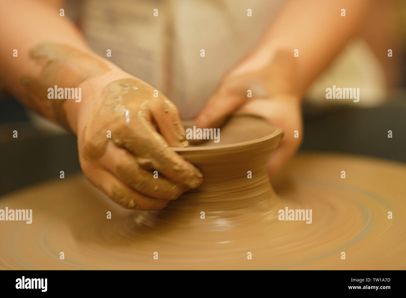 Child sculpting clay on a pottery wheel Stock Photo - Alamy