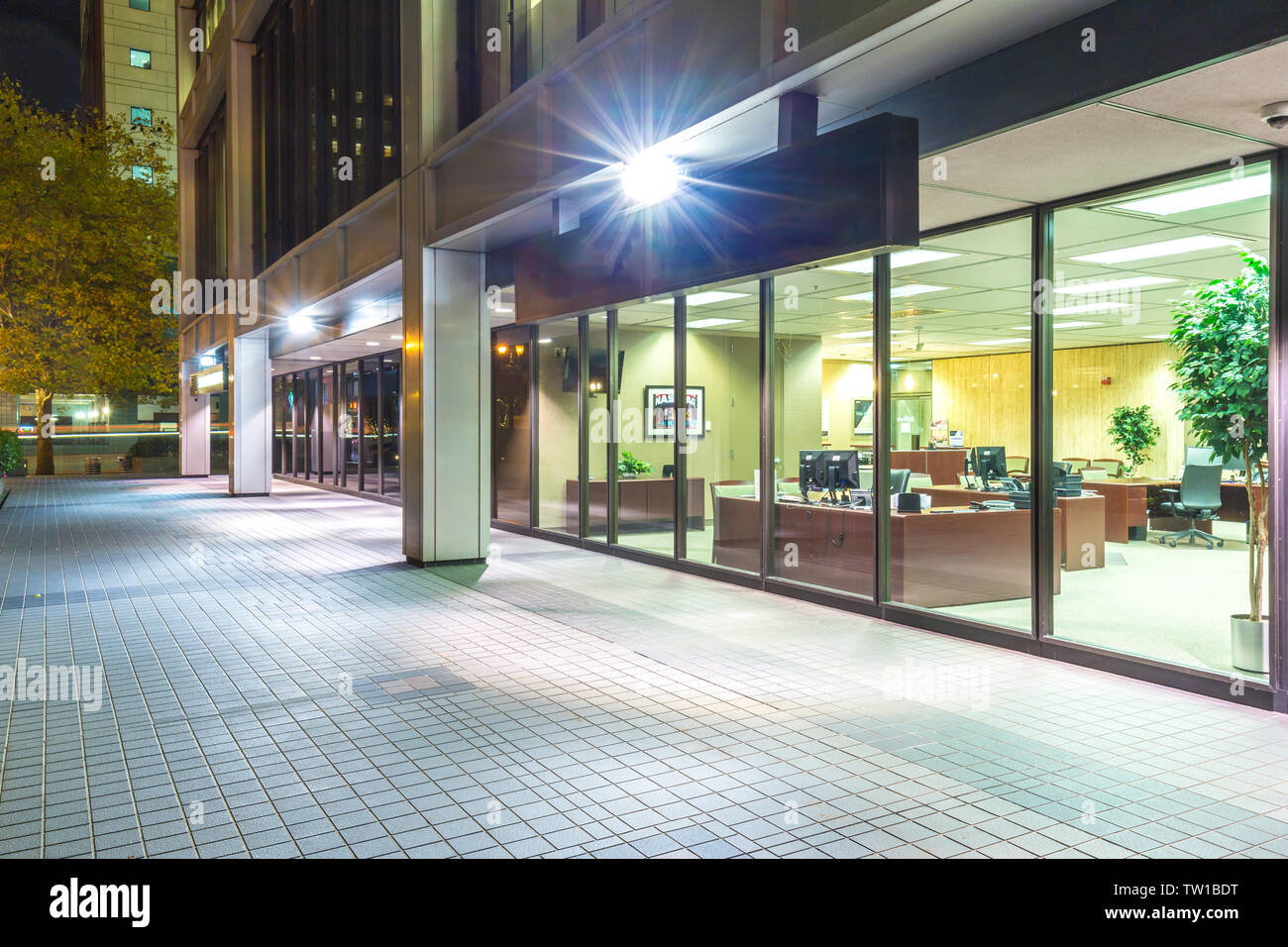 modern office building and empty brick footpath at night Stock Photo ...