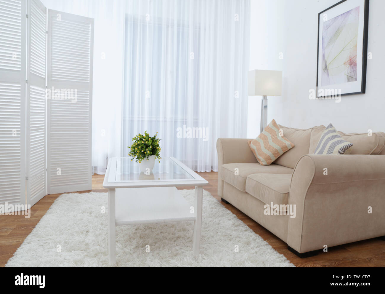 Interior of beautiful living room with folding screen and sofa Stock ...