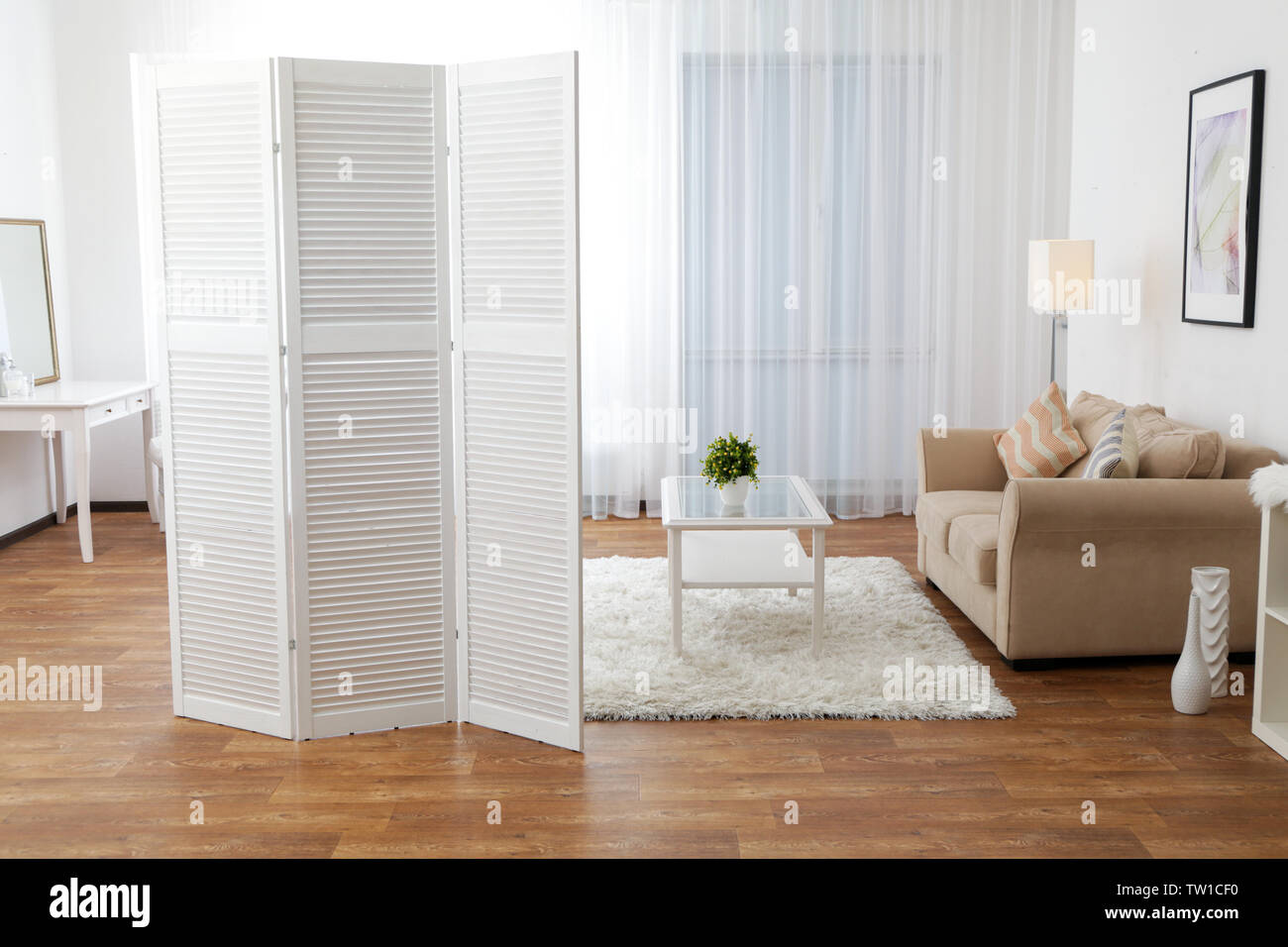 Interior of beautiful living room with folding screen and sofa Stock ...