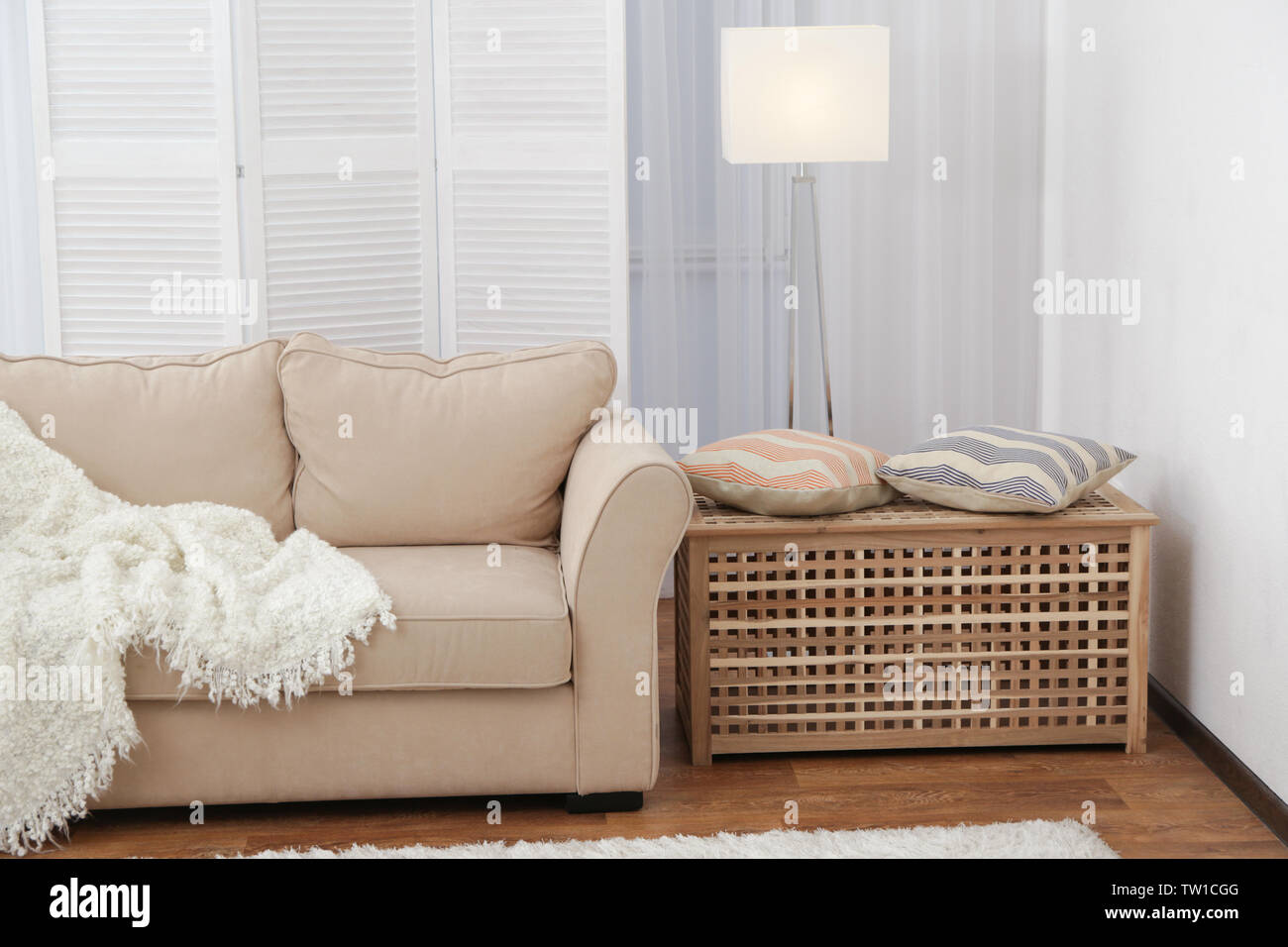 Interior of beautiful living room with folding screen and sofa Stock ...