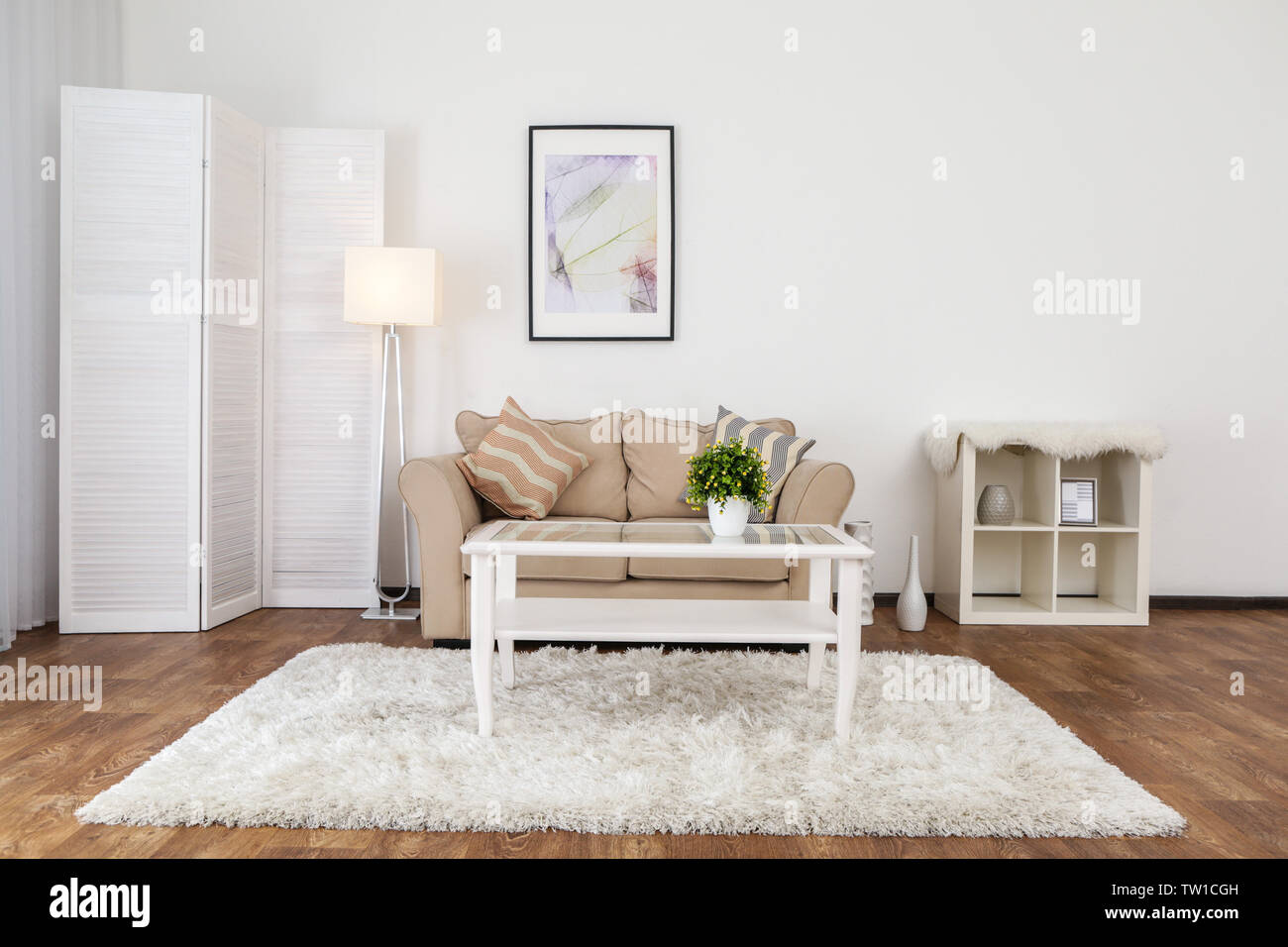 Interior of beautiful living room with folding screen and sofa Stock ...