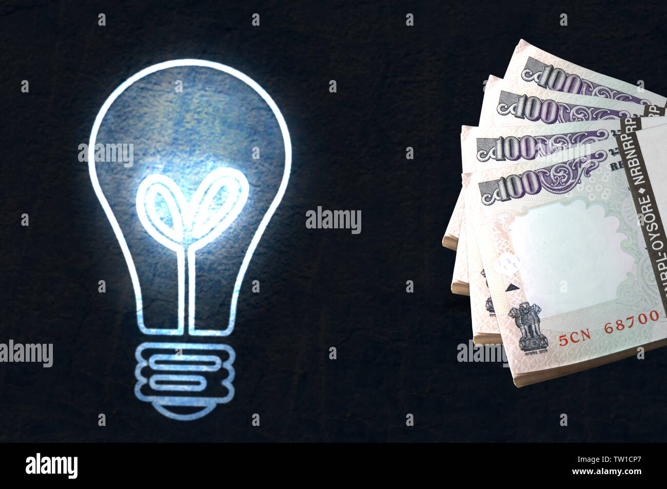 Glowing lightbulb with bundles of hundred rupees banknotes Stock Photo ...