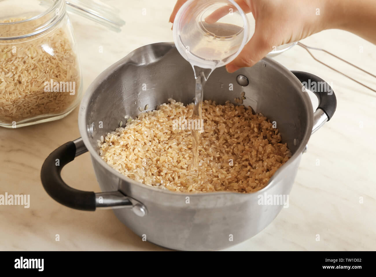 Hand pouring rice hi-res stock photography and images - Alamy