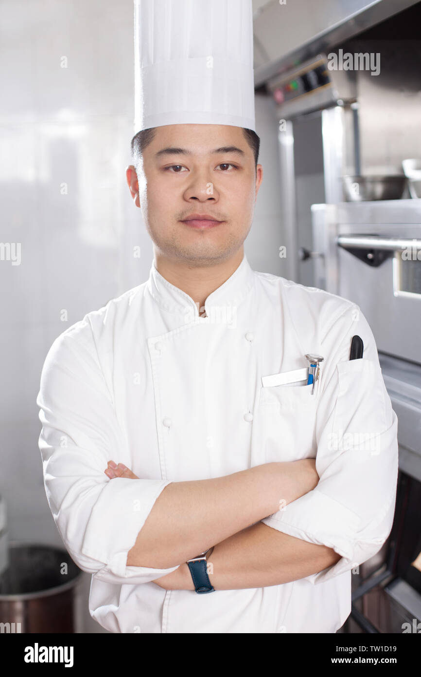 young chinese man chelf in modern kitchen Stock Photo - Alamy
