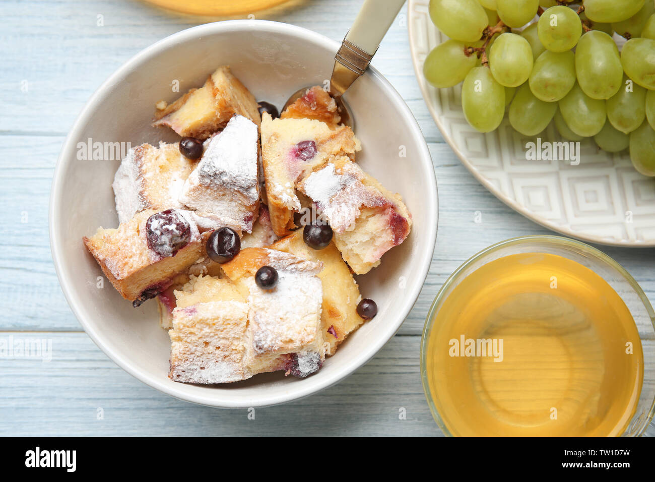 Delicious bread pudding with fruits and tea on wooden table Stock Photo ...