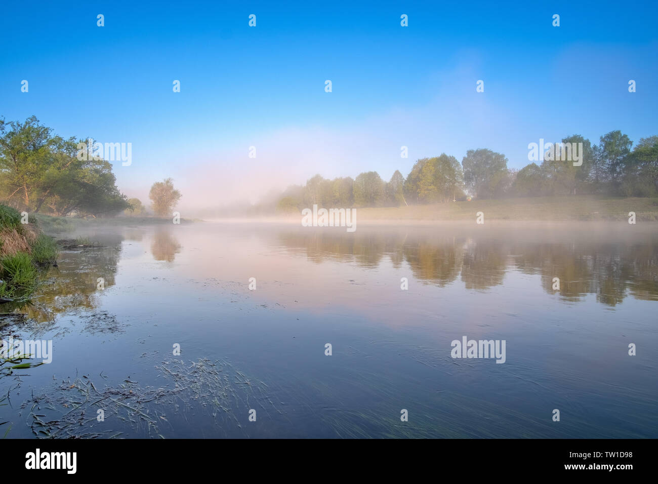 Colorful view of the river shrouded in mist creeping over the water ...