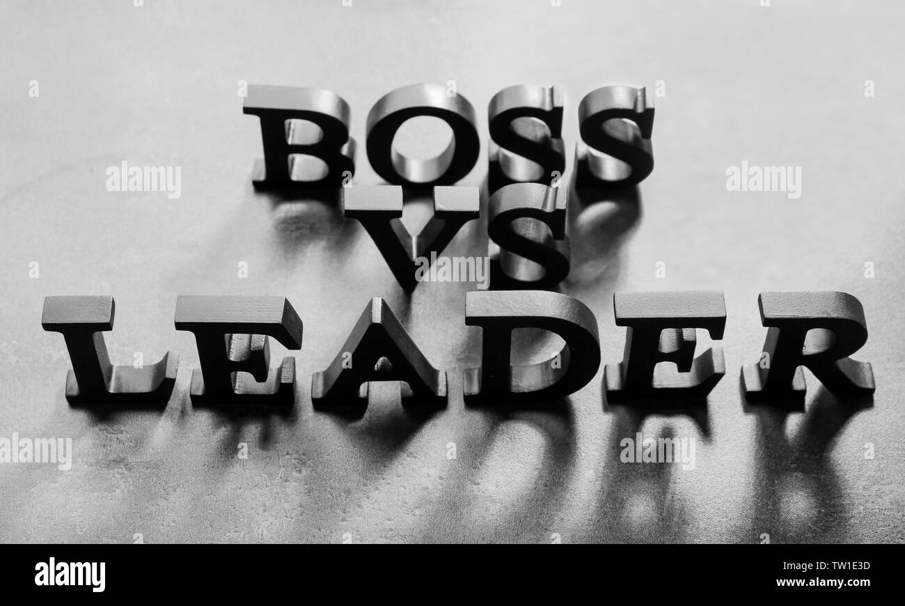 Black letters forming text BOSS VS LEADER on grey background Stock ...