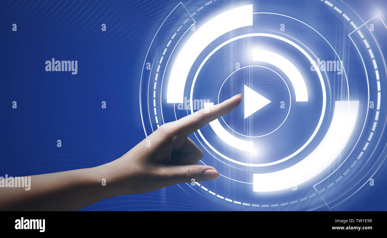Female finger pushing digital Play button on blue background, empty ...