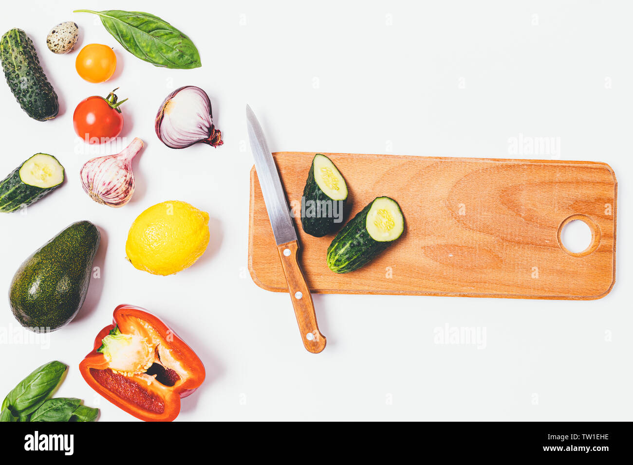 Flat lay cooking healthy salad of fresh vegetables on white background ...