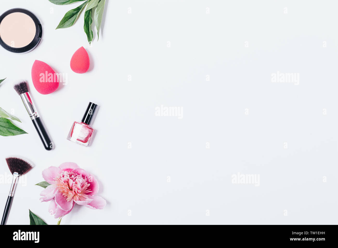 Side flat lay border composition of feminine makeup products and ...