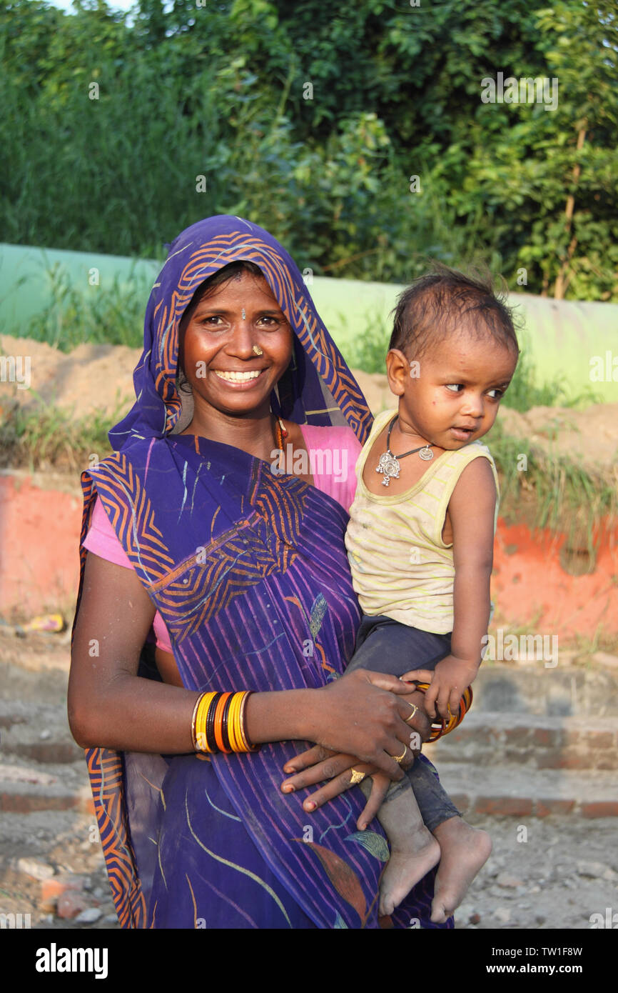 Woman carrying her baby and smiling, India Stock Photo - Alamy Woman carrying her baby and smiling, India Stock Photo - Alamy