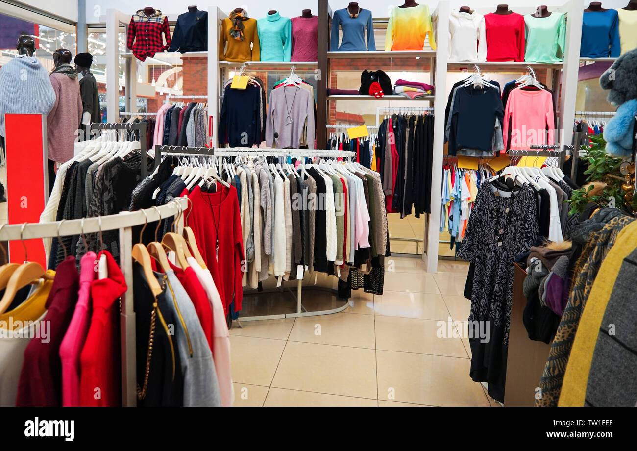 Different clothes in modern store Stock Photo - Alamy