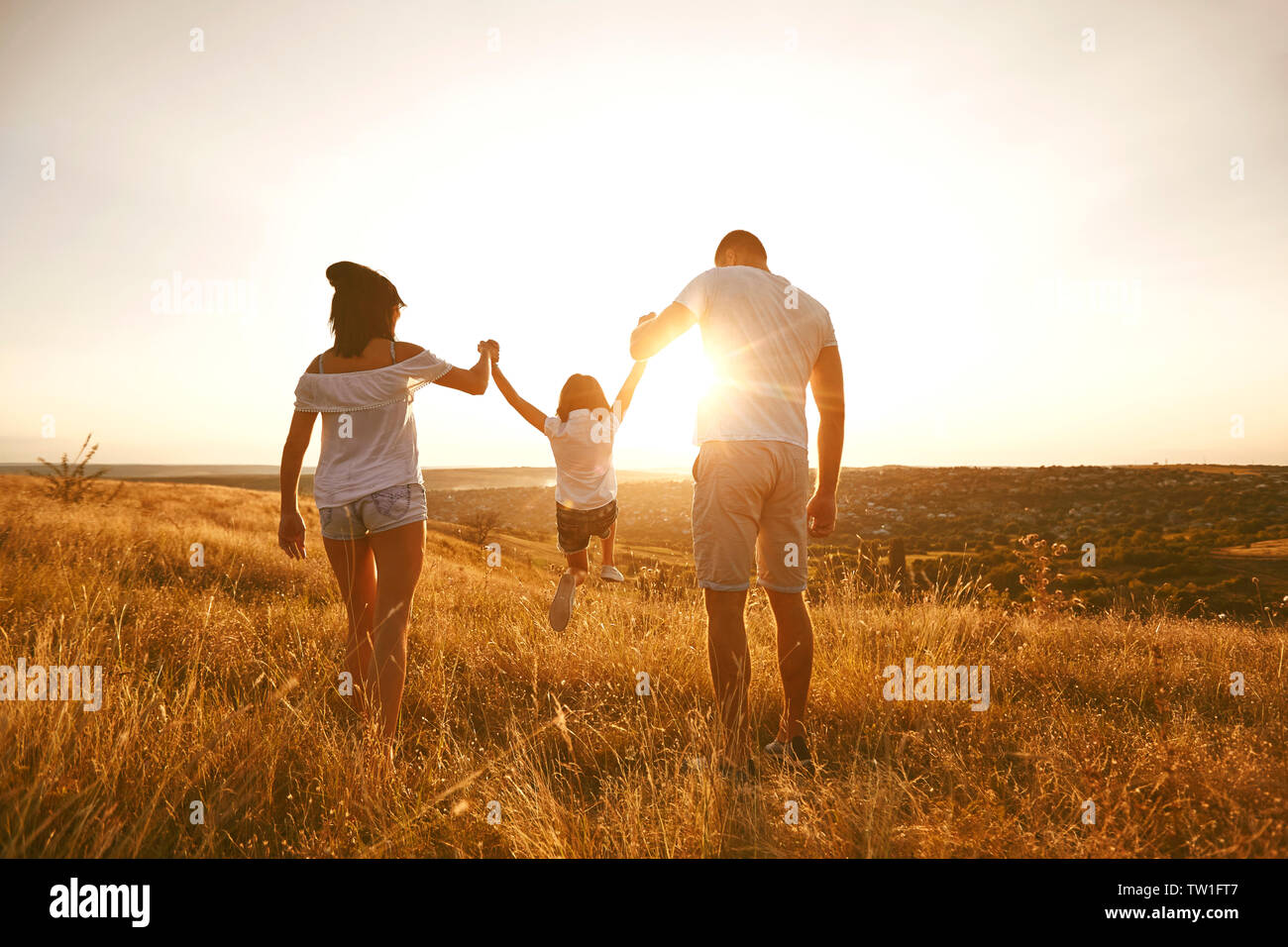 Family walk sunset hi-res stock photography and images - Alamy