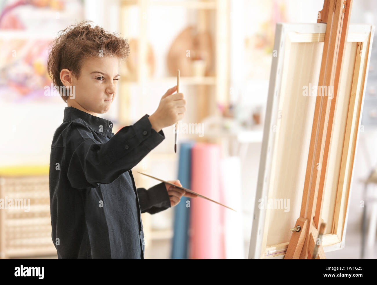 Cute little artist painting picture in studio Stock Photo - Alamy