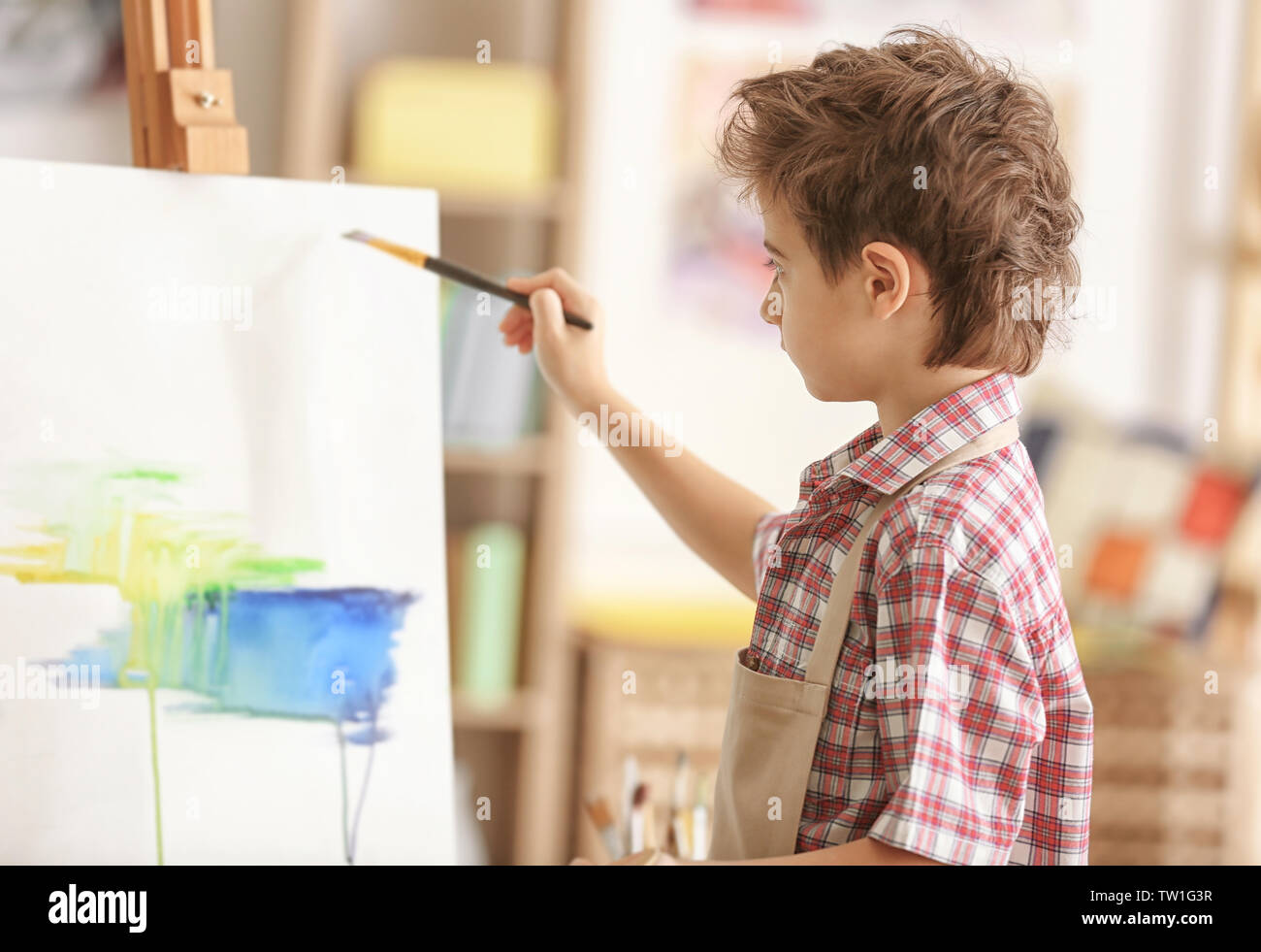 Cute little artist painting picture in studio Stock Photo - Alamy