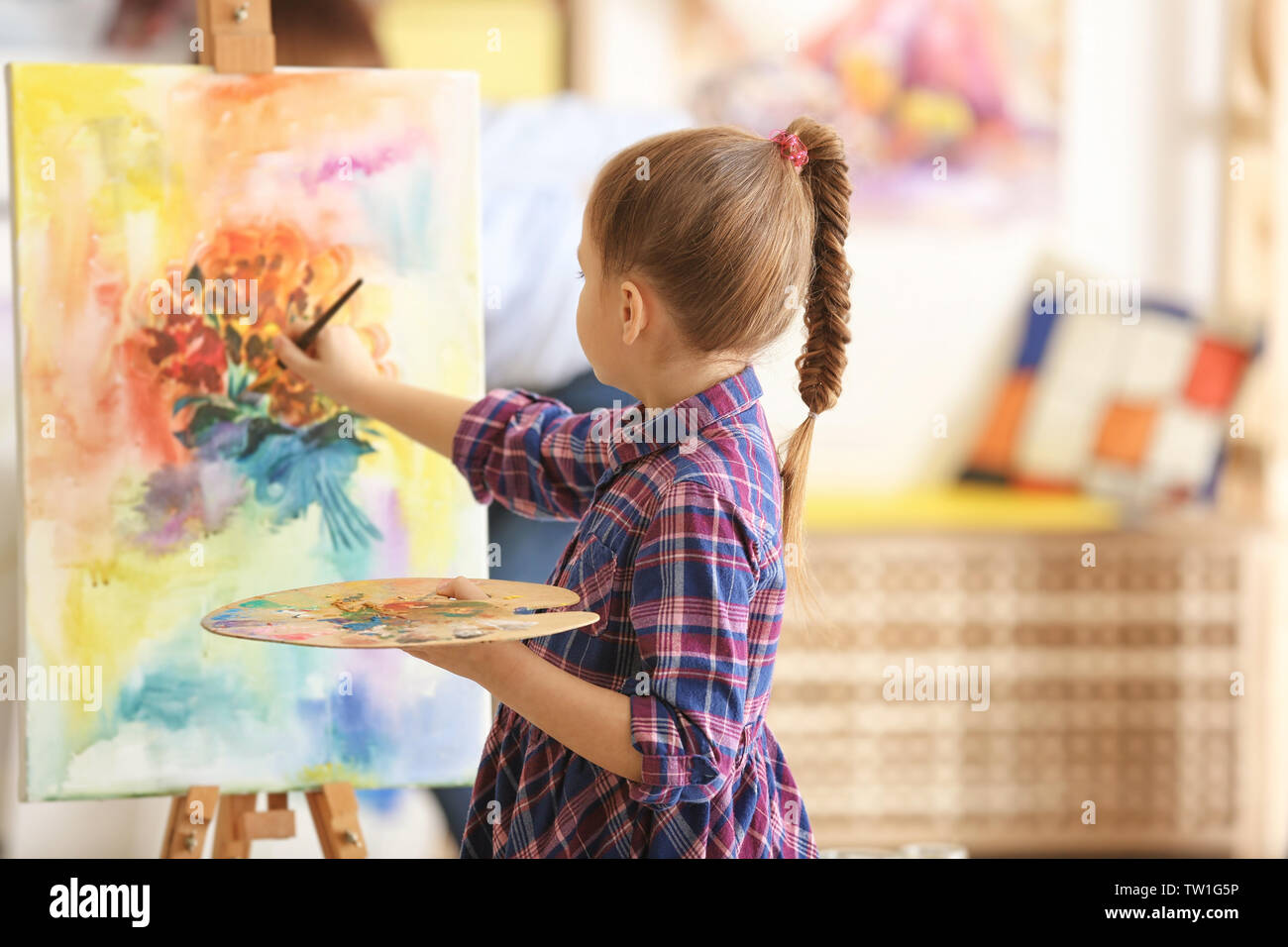 Cute little artist painting picture in studio Stock Photo - Alamy