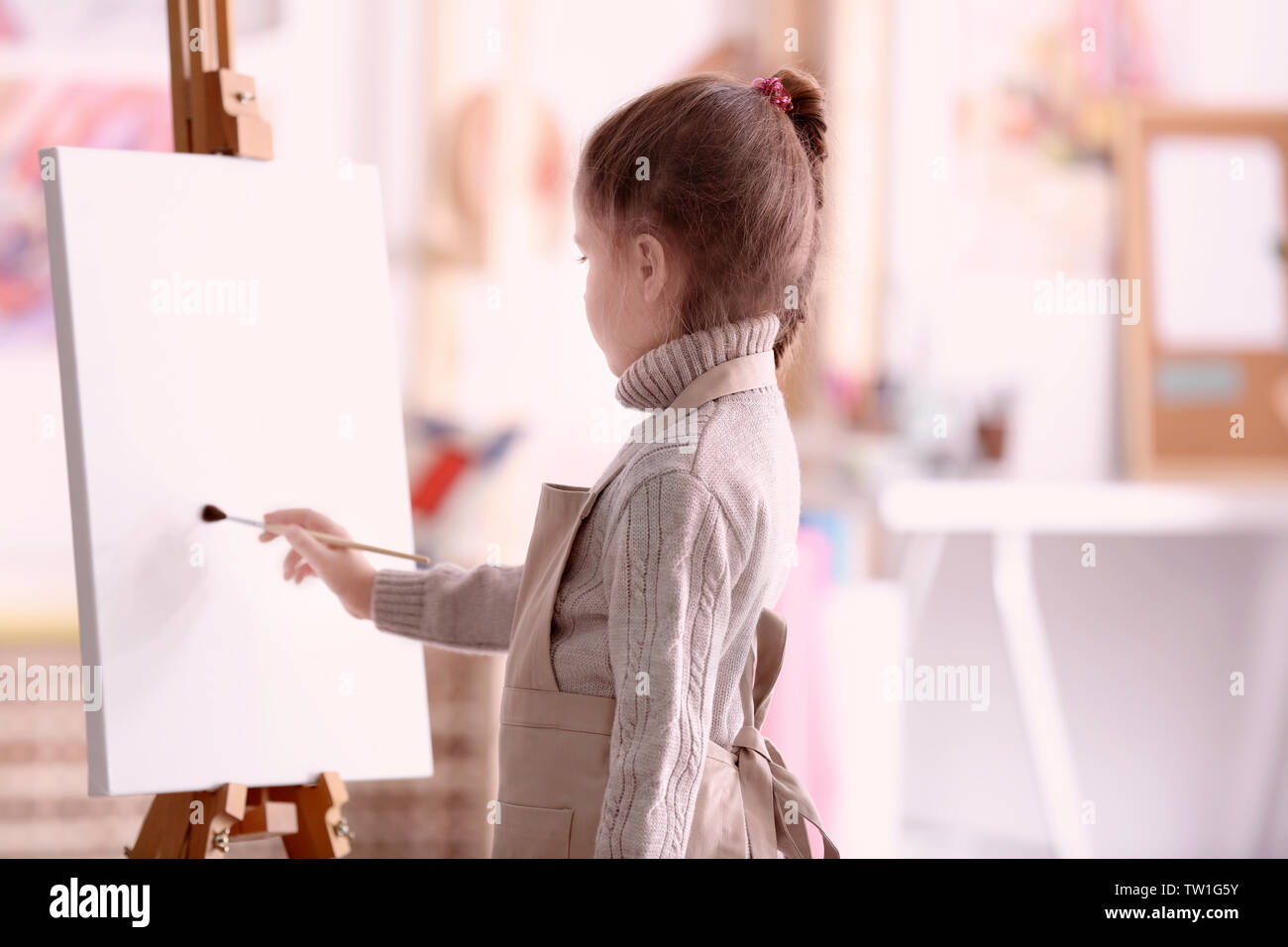 Cute little artist painting picture in studio Stock Photo - Alamy