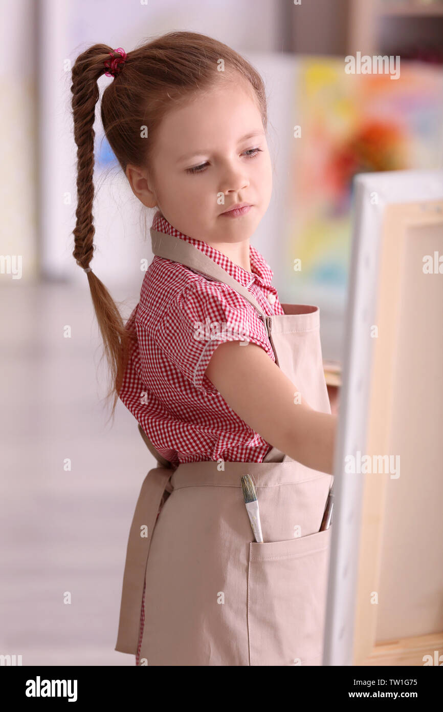 Cute little artist painting picture in studio Stock Photo - Alamy