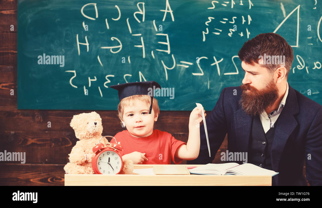 Kid happy studies individually with father, at home. Individual ...